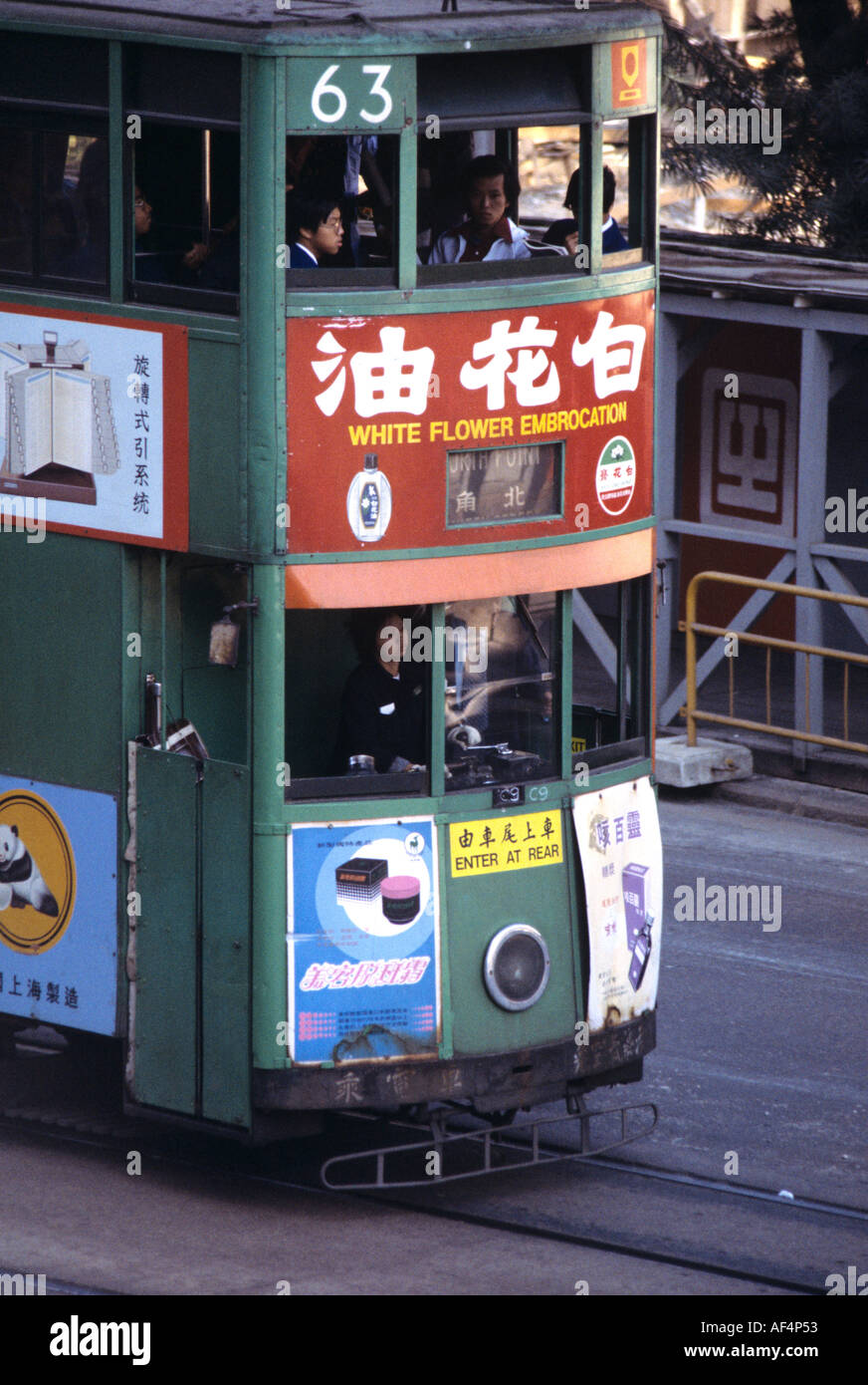 Close up of front of typical old green tram with Chinese advert for ...