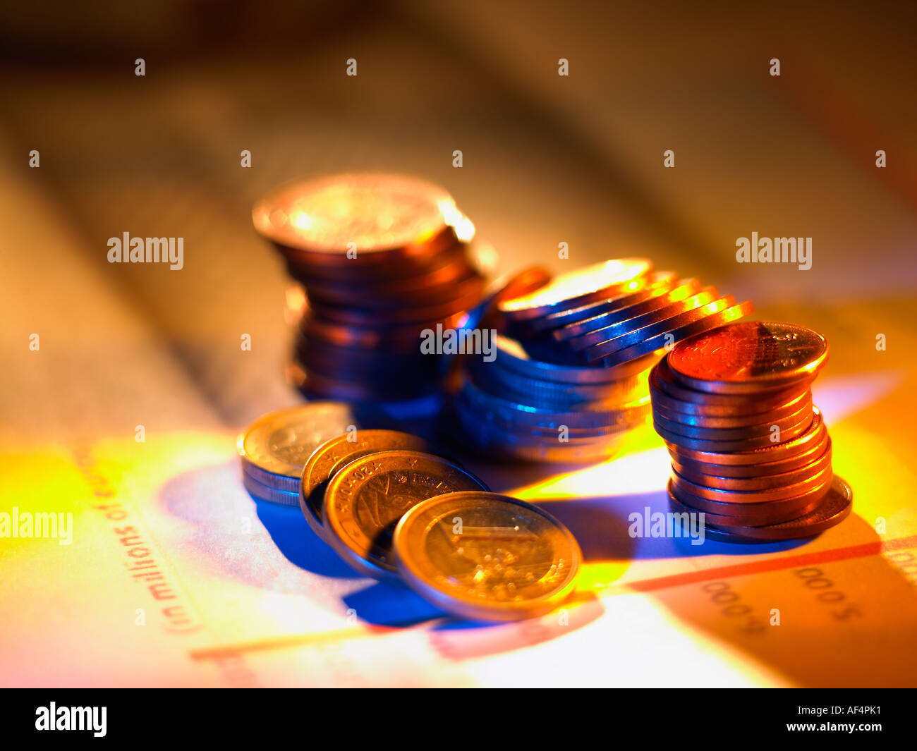 piles of money balancing Stock Photo - Alamy