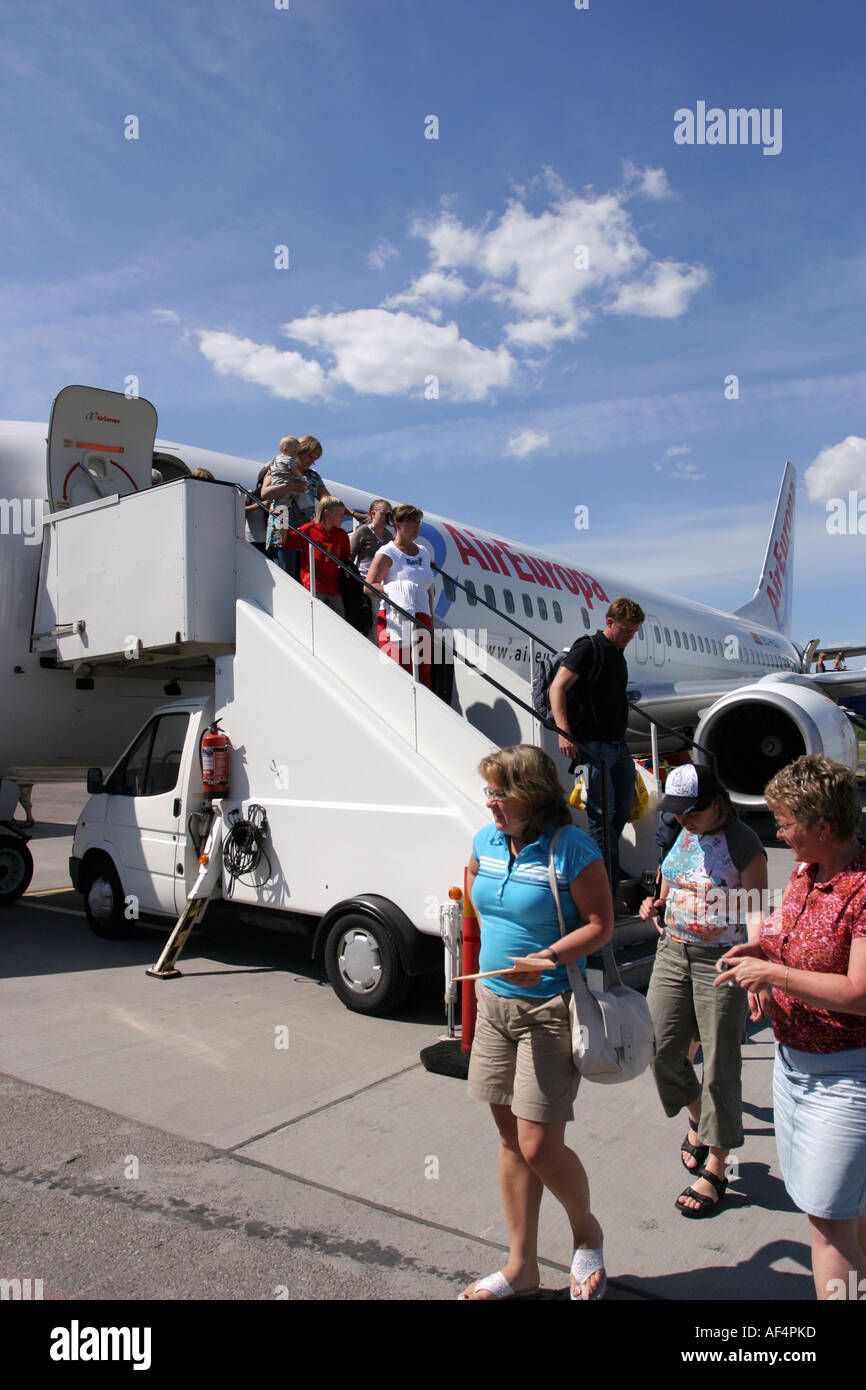 Passengers exiting an airplane at an airport Stock Photo - Alamy