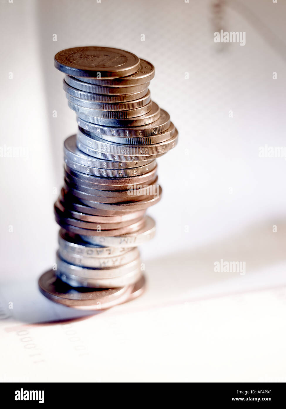 piles of money balancing Stock Photo - Alamy