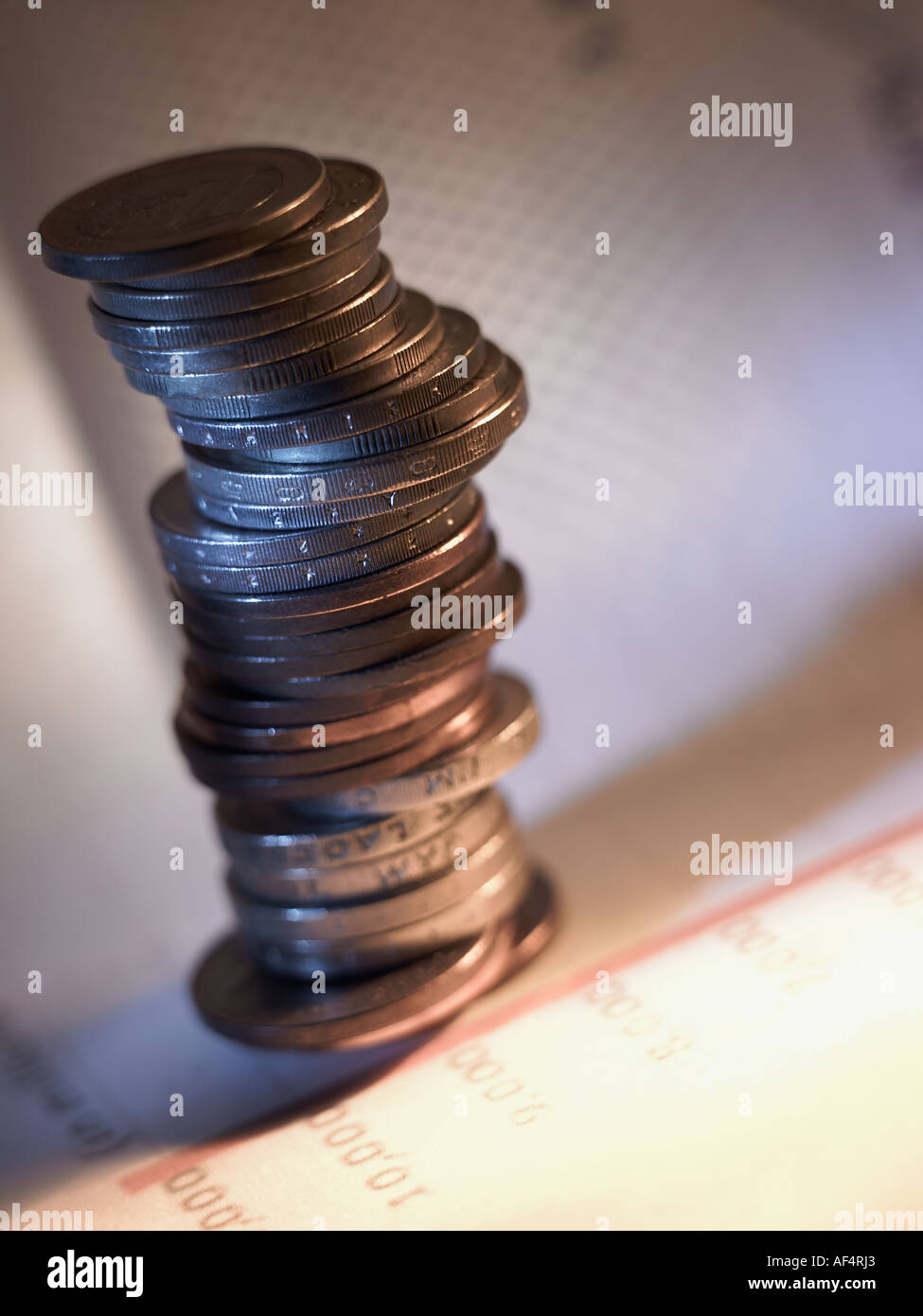piles of money balancing Stock Photo - Alamy