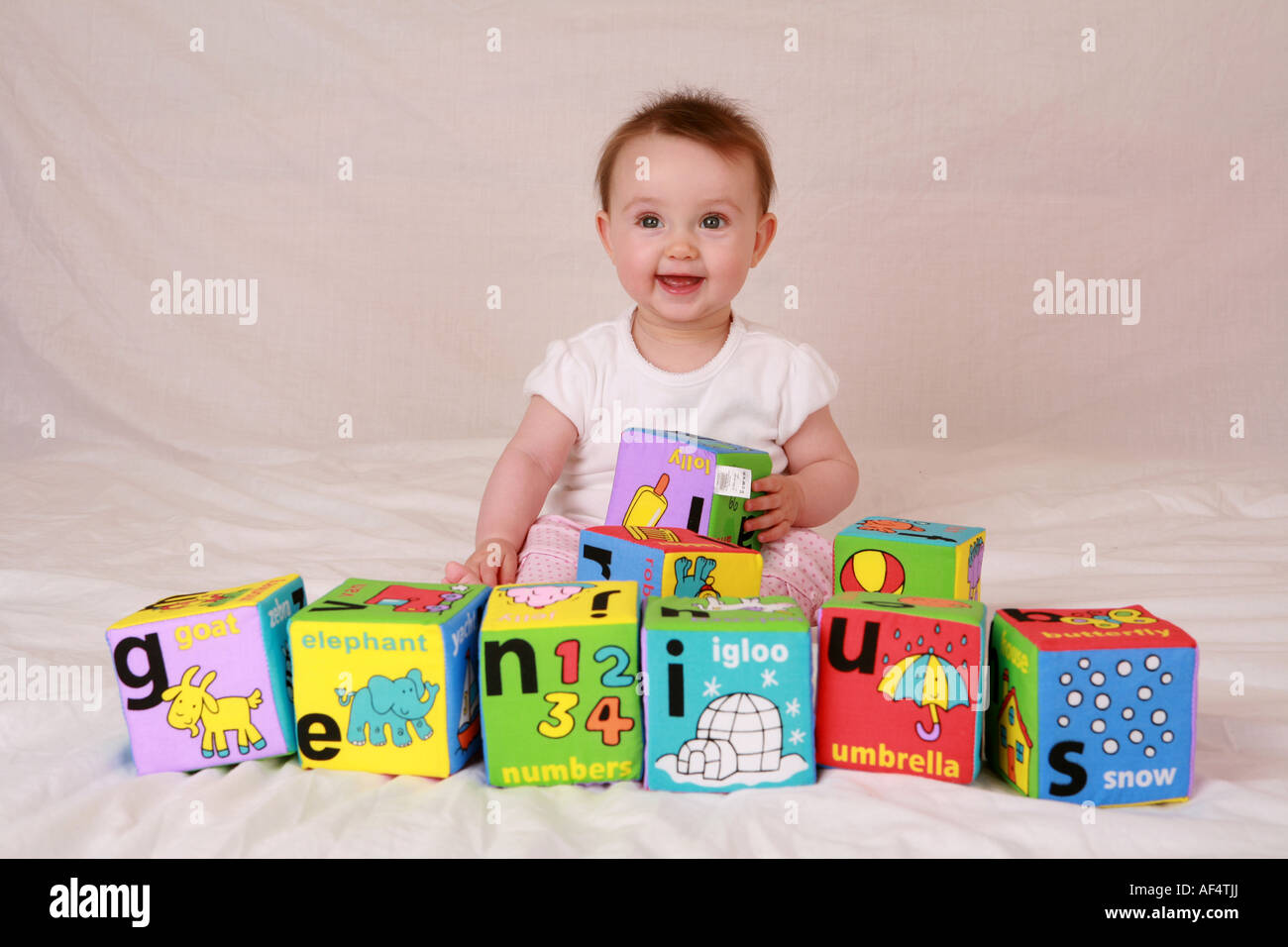 Smiling happy genius smart intelligent newborn baby infant sitting ...