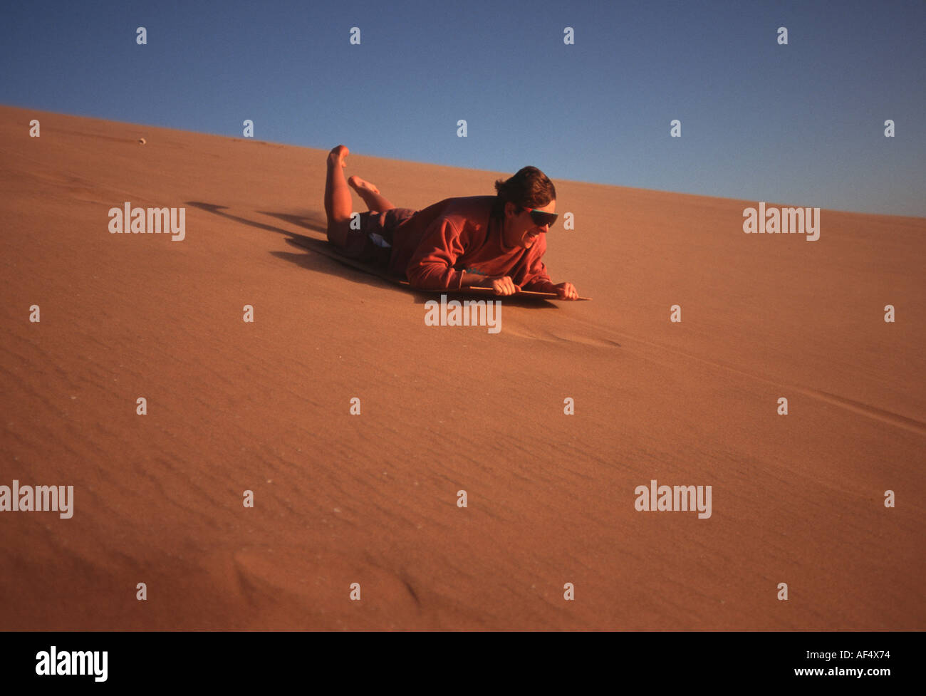 Sand boarding on sand dunes Namib Naukluft desert Stock Photo - Alamy