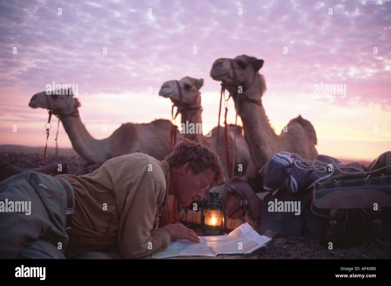Benedict Allen reading maps during journey Stock Photo - Alamy