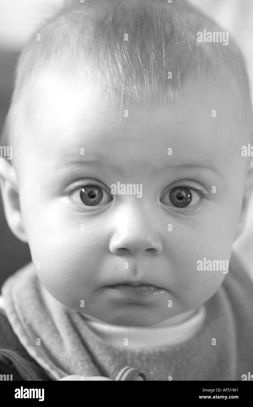 Portrait of a baby boy looking surprised Stock Photo - Alamy