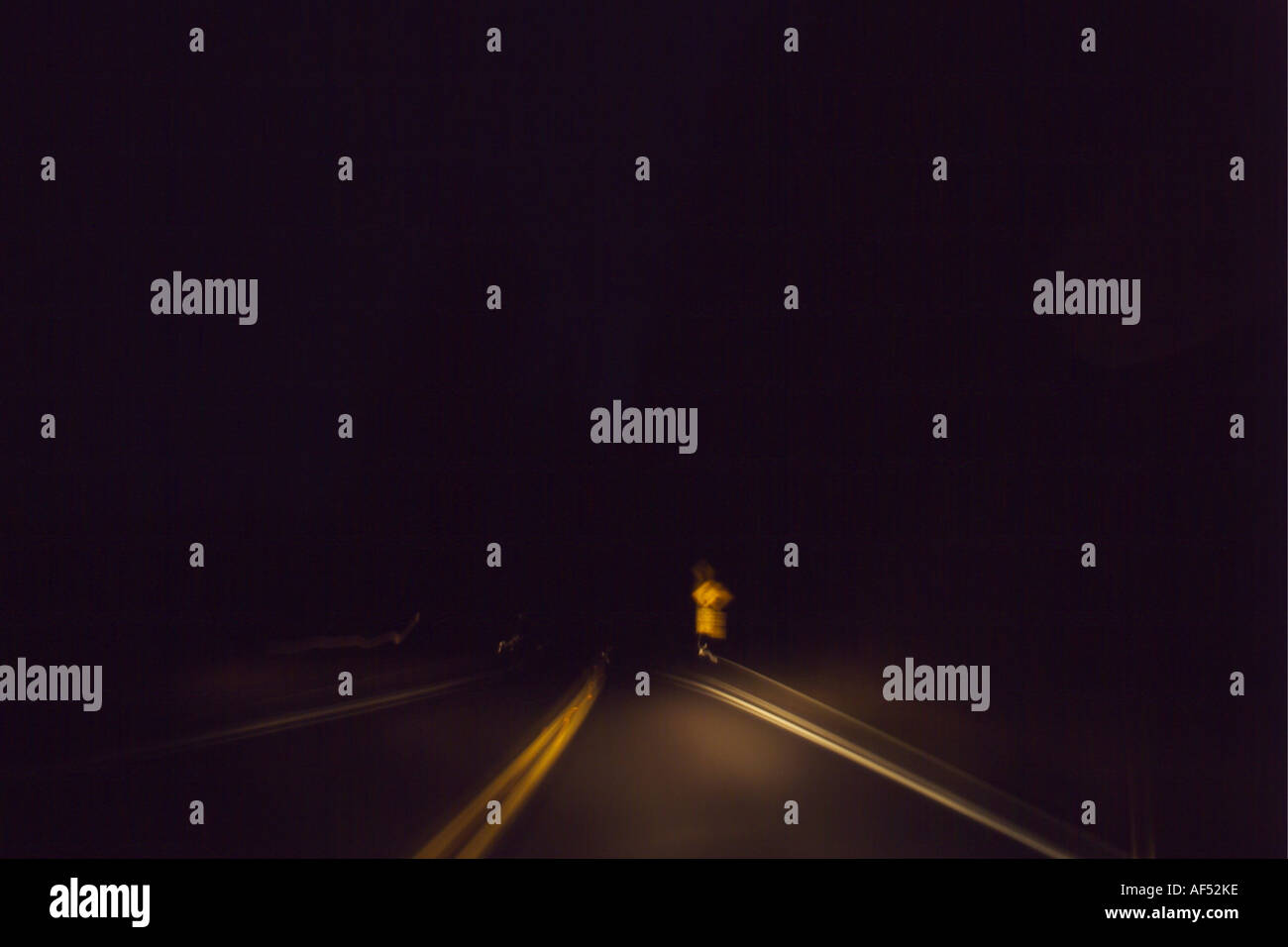 Road sign on the roadside at night Stock Photo - Alamy