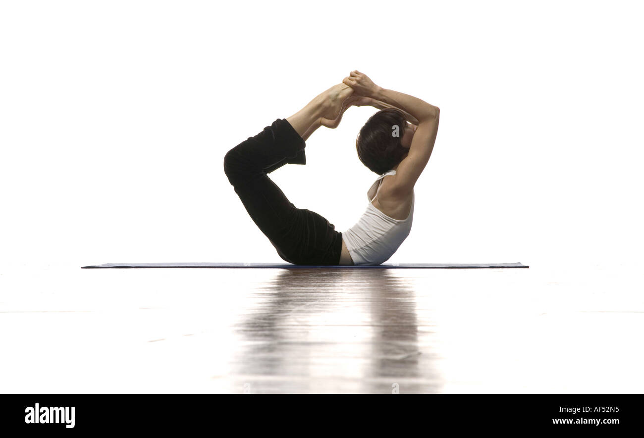 Side profile of a woman performing bow pose Stock Photo - Alamy