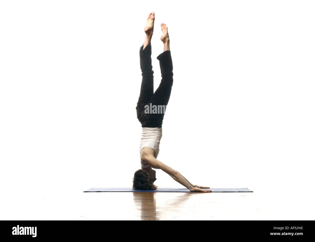 Side profile of a woman doing headstand Stock Photo - Alamy