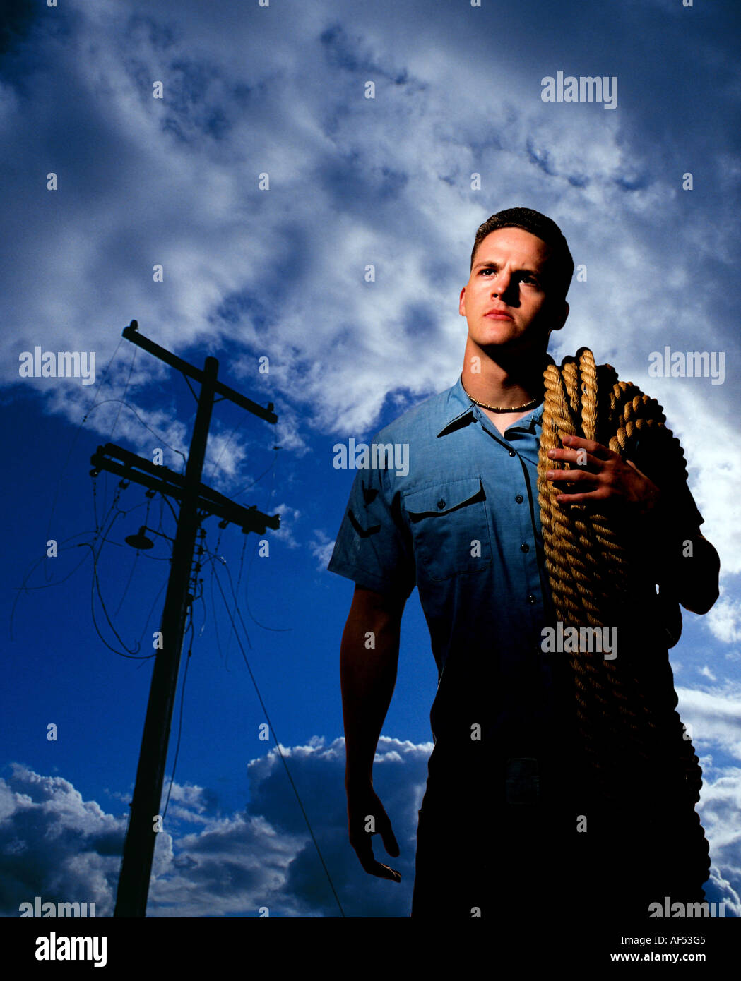 Low angle view of a young man carrying a rope on his shoulders Stock ...