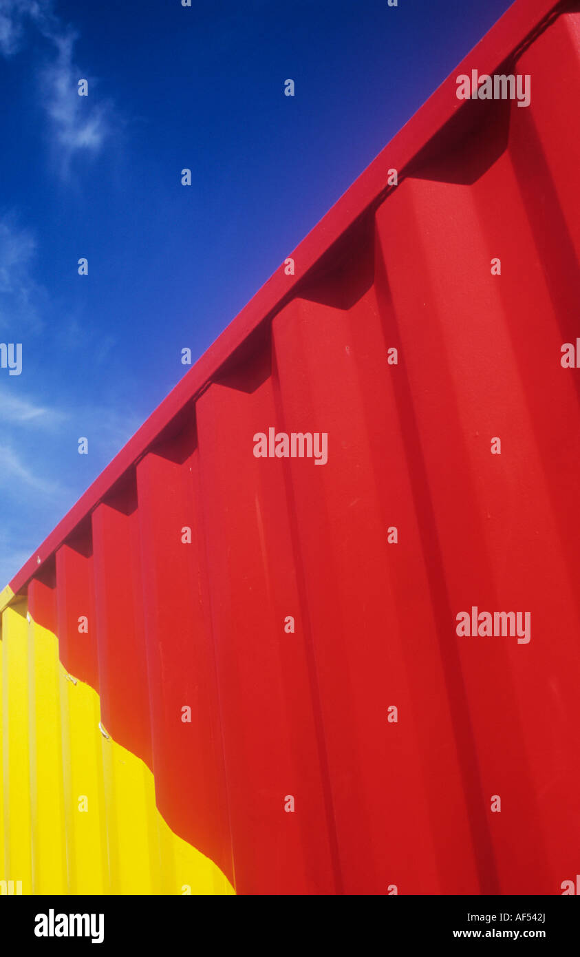 Detail of brightly painted red and yellow heavy duty corrugated metal ...