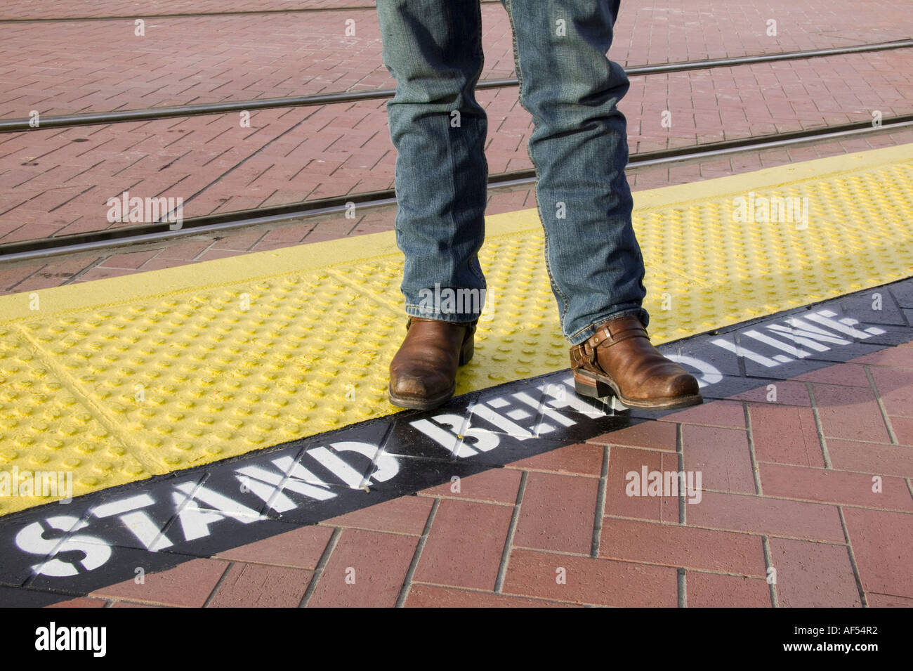 Low section view of a person standing on a platform Stock Photo - Alamy