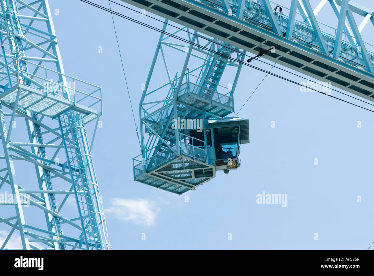 large blue construction crane in use at a shipbuilding facility in ...