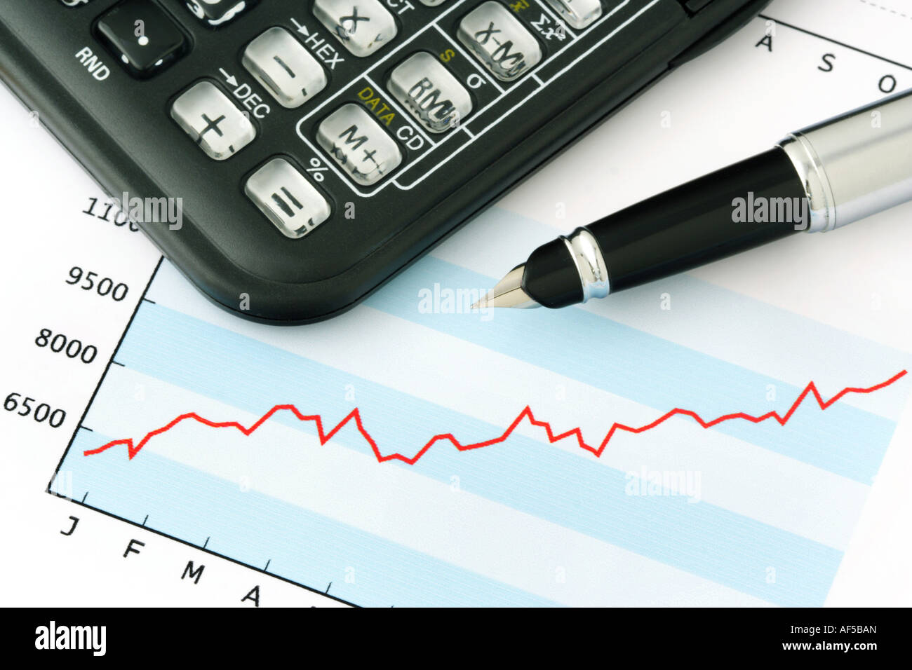 Pen and Calculator on Blue Graph Stock Photo - Alamy