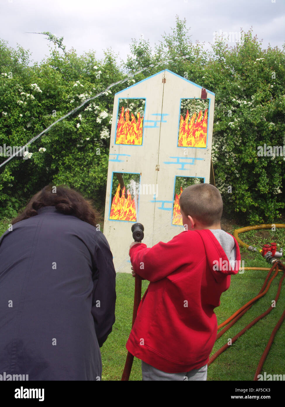 Summer village fete Suffolk England fire hose game Stock Photo - Alamy