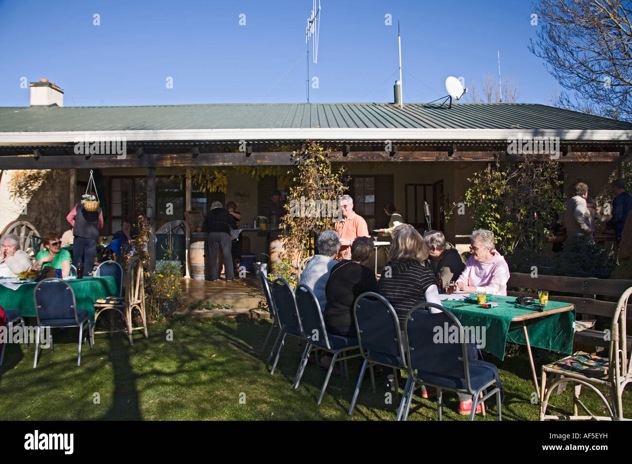 FAIRLIE SOUTH ISLAND NEW ZEALAND May Group of tourists dining outdoors ...