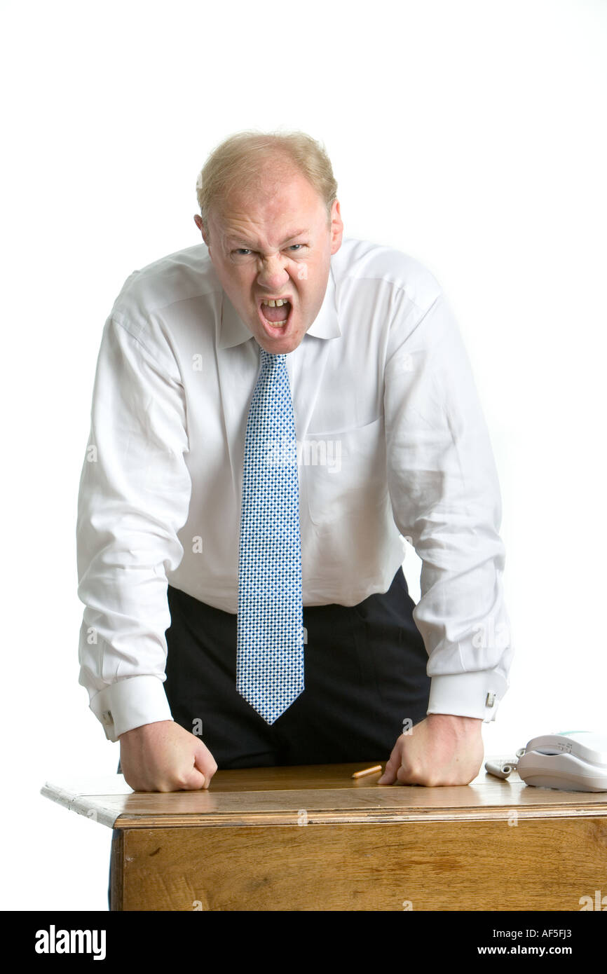 Angry business man at his desk Stock Photo - Alamy