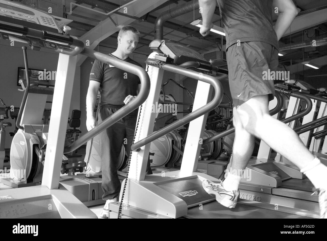 Fitness instructor in gym Black and White Stock Photos & Images - Alamy