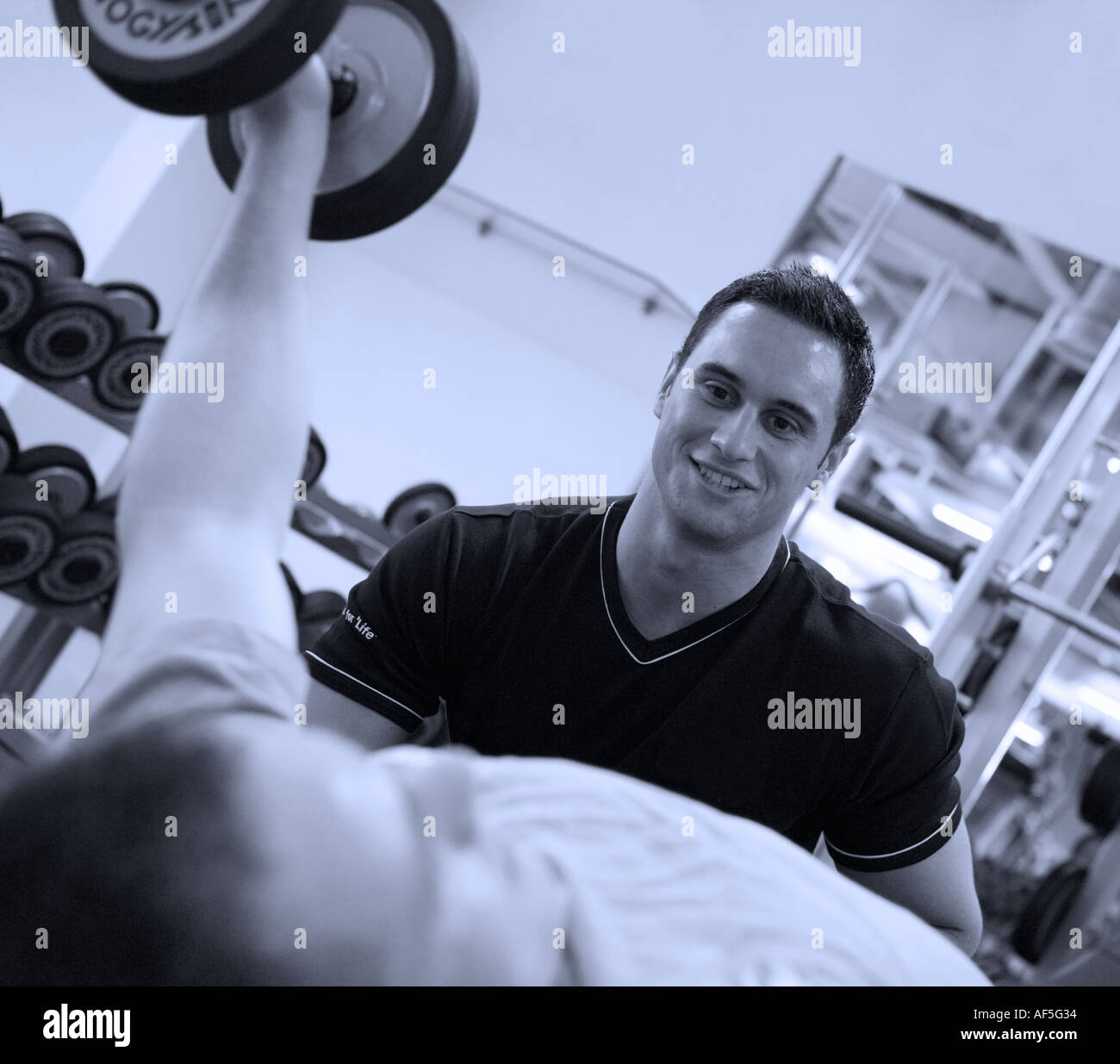 PERSONAL FITNESS TRAINER TEACHING IN A GYM Stock Photo - Alamy