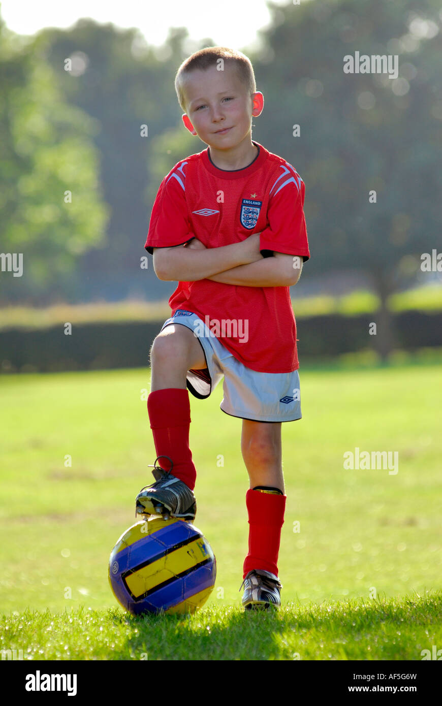 Young Boy Wearing England Kit, Standing with Football Stock Photo - Alamy