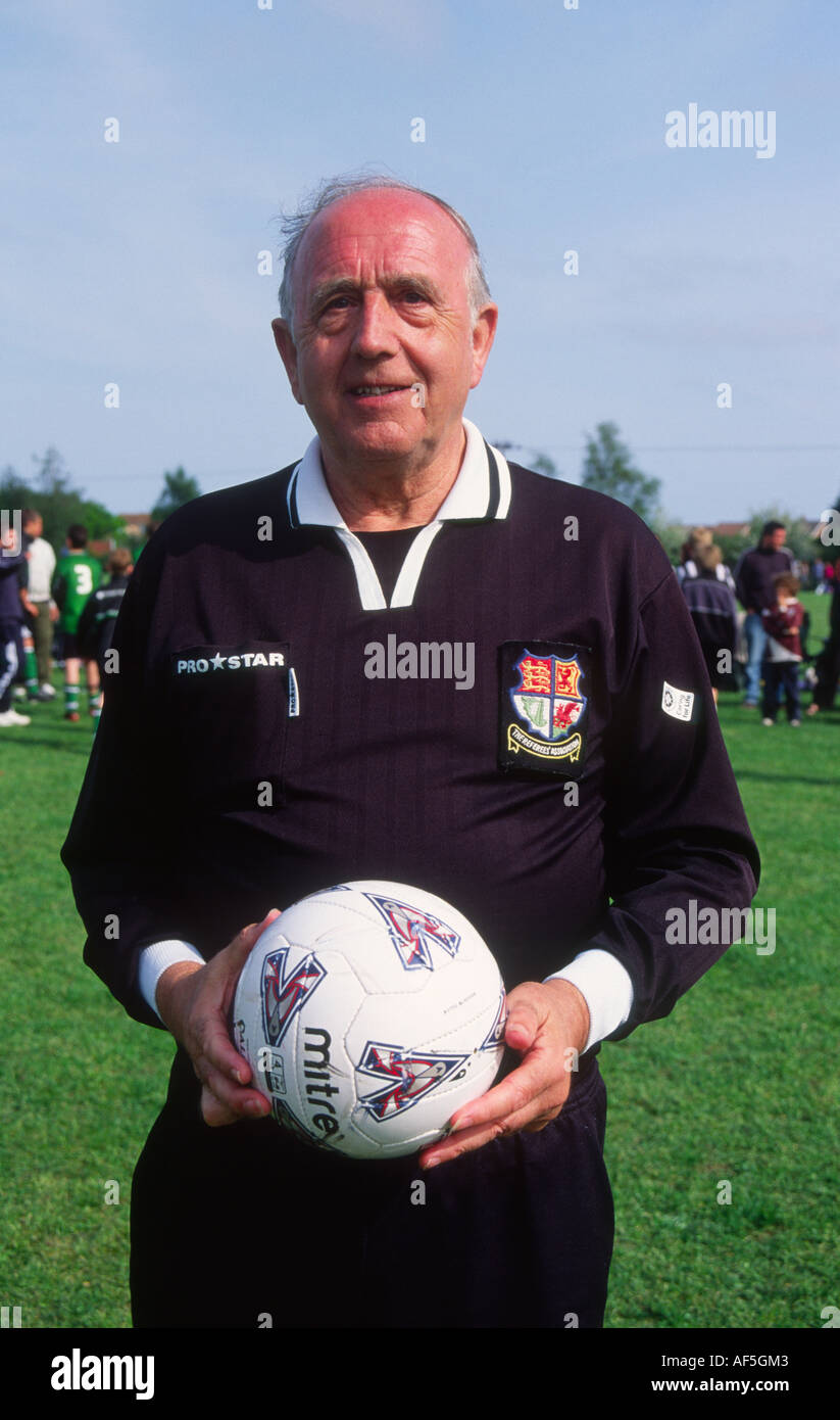 Football referee holding a soccer ball at a children's tournament Stock ...