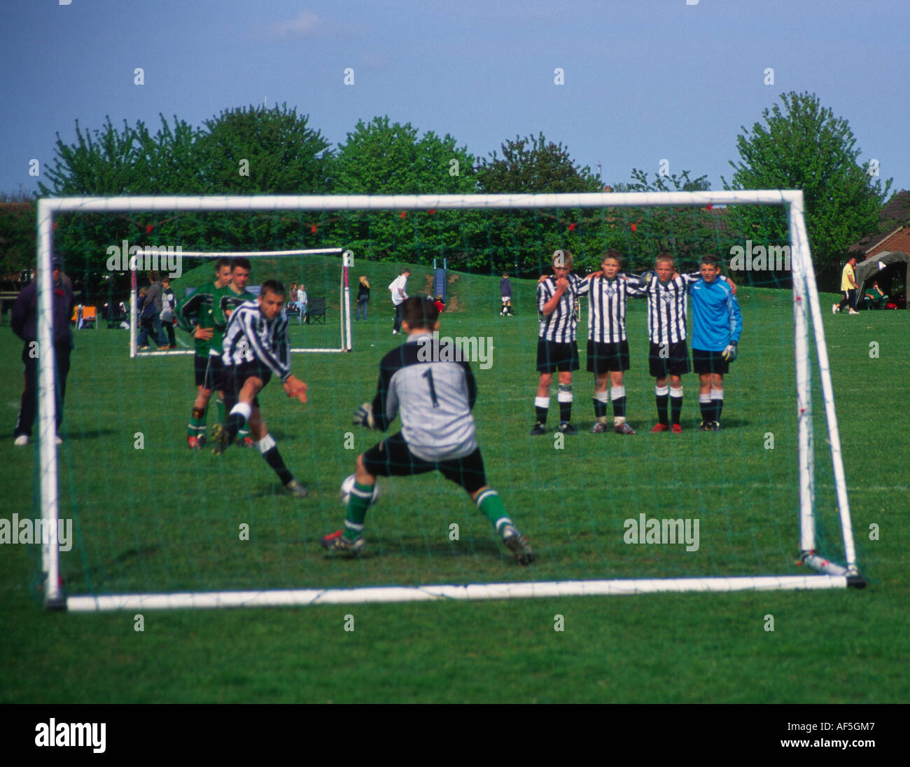 Children's football tournament. View of goalkeeper from behind the net ...