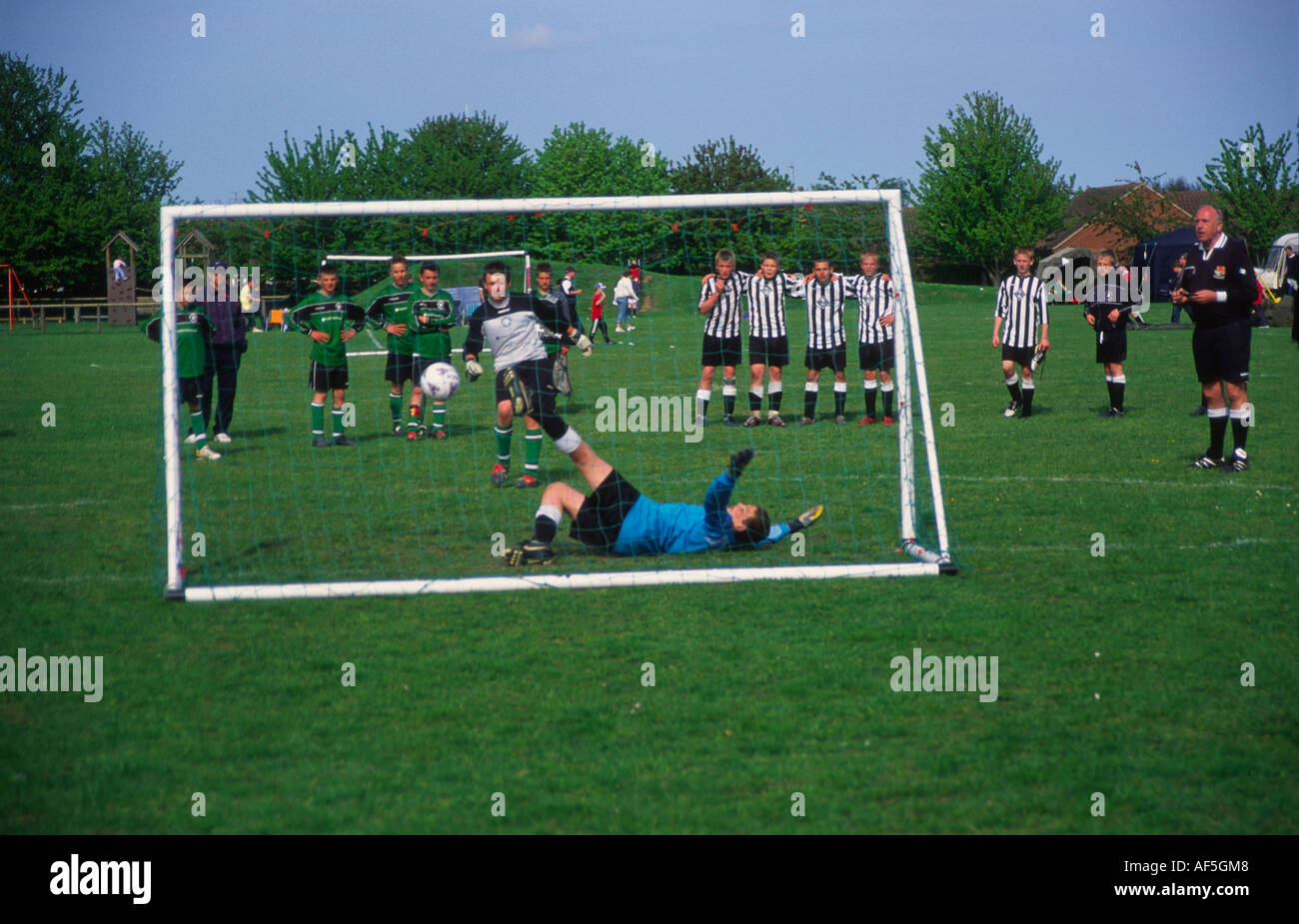 Children's football tournament. View of goalkeeper from behind the net ...