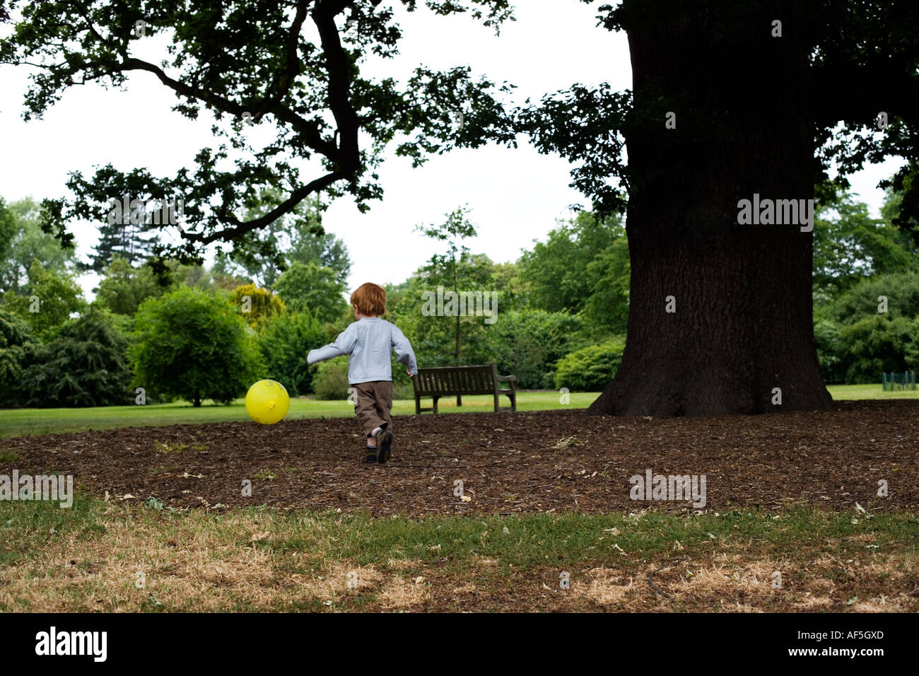 Child chasing ball hi-res stock photography and images - Alamy