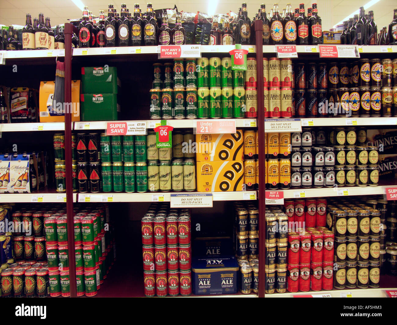 Cans and bottles on shelf display in supermarket shop Stock Photo - Alamy