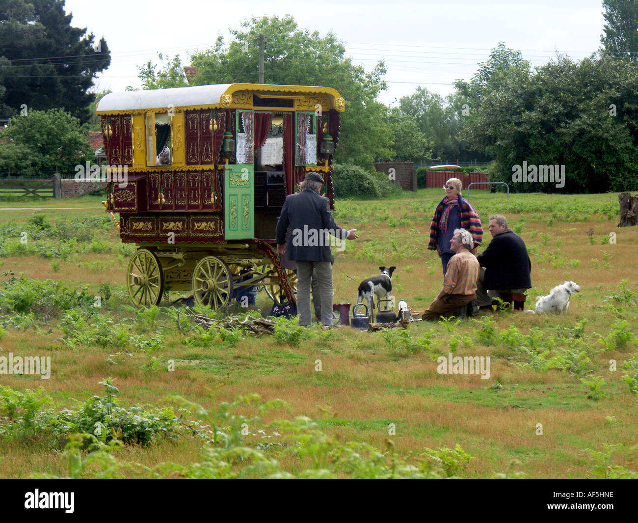 Old gypsy caravan and people on commonland in Suffolk England Stock ...