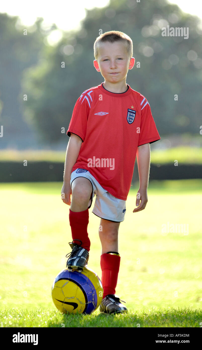 Young Boy Standing with Football Stock Photo - Alamy