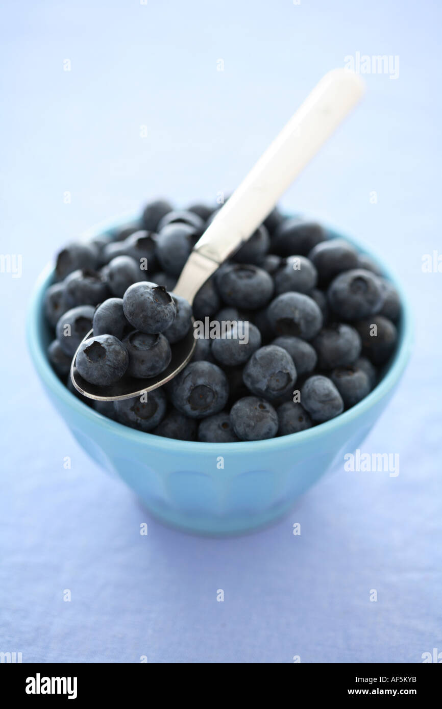 Blueberries in bowl with spoon Stock Photo - Alamy
