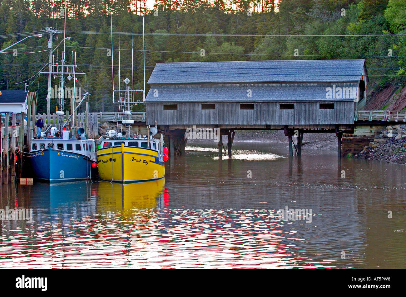 Fishing Boats and Covered Bridge Stock Photo - Alamy