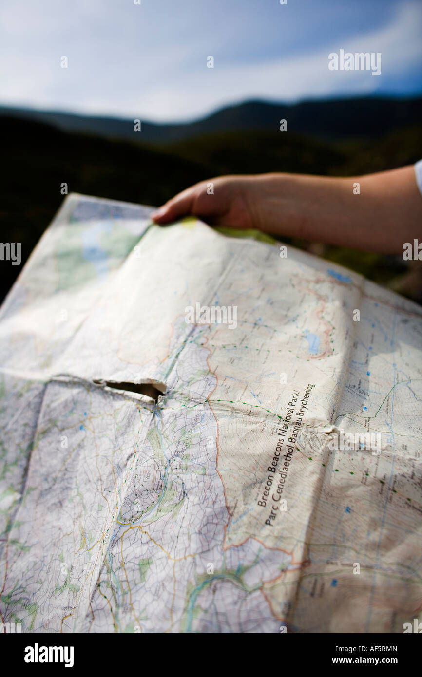 hands on an OS map Brecon Beacons National Park Powys Wales Stock Photo ...