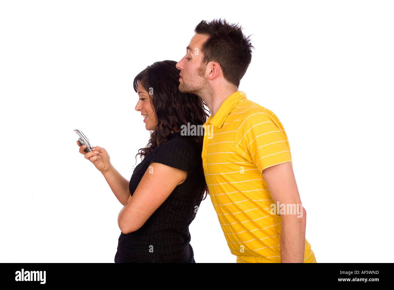 Young couple texting on mobile phones Stock Photo - Alamy