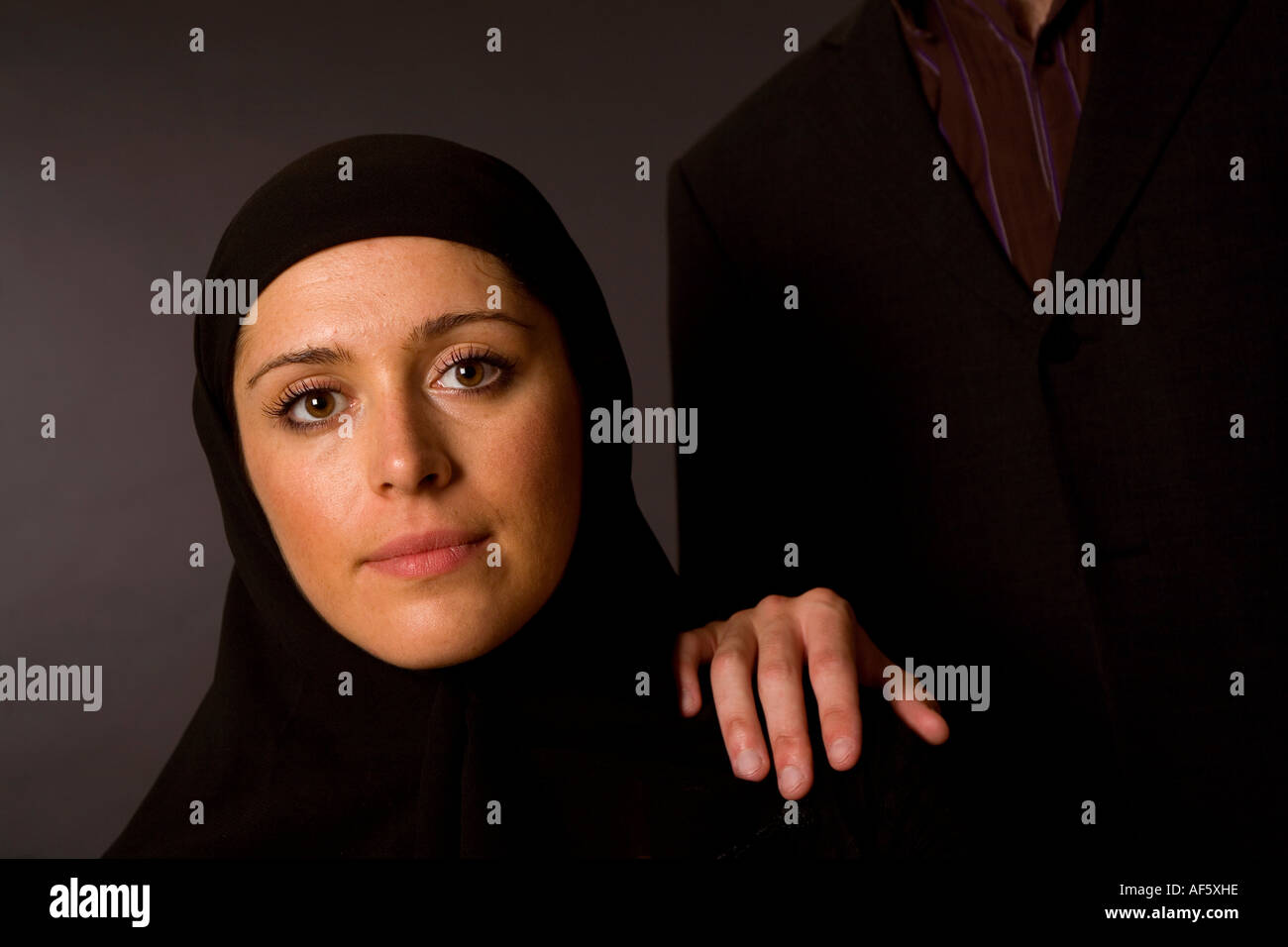 Man standing beside a Woman wearing a hijab burka Stock Photo - Alamy