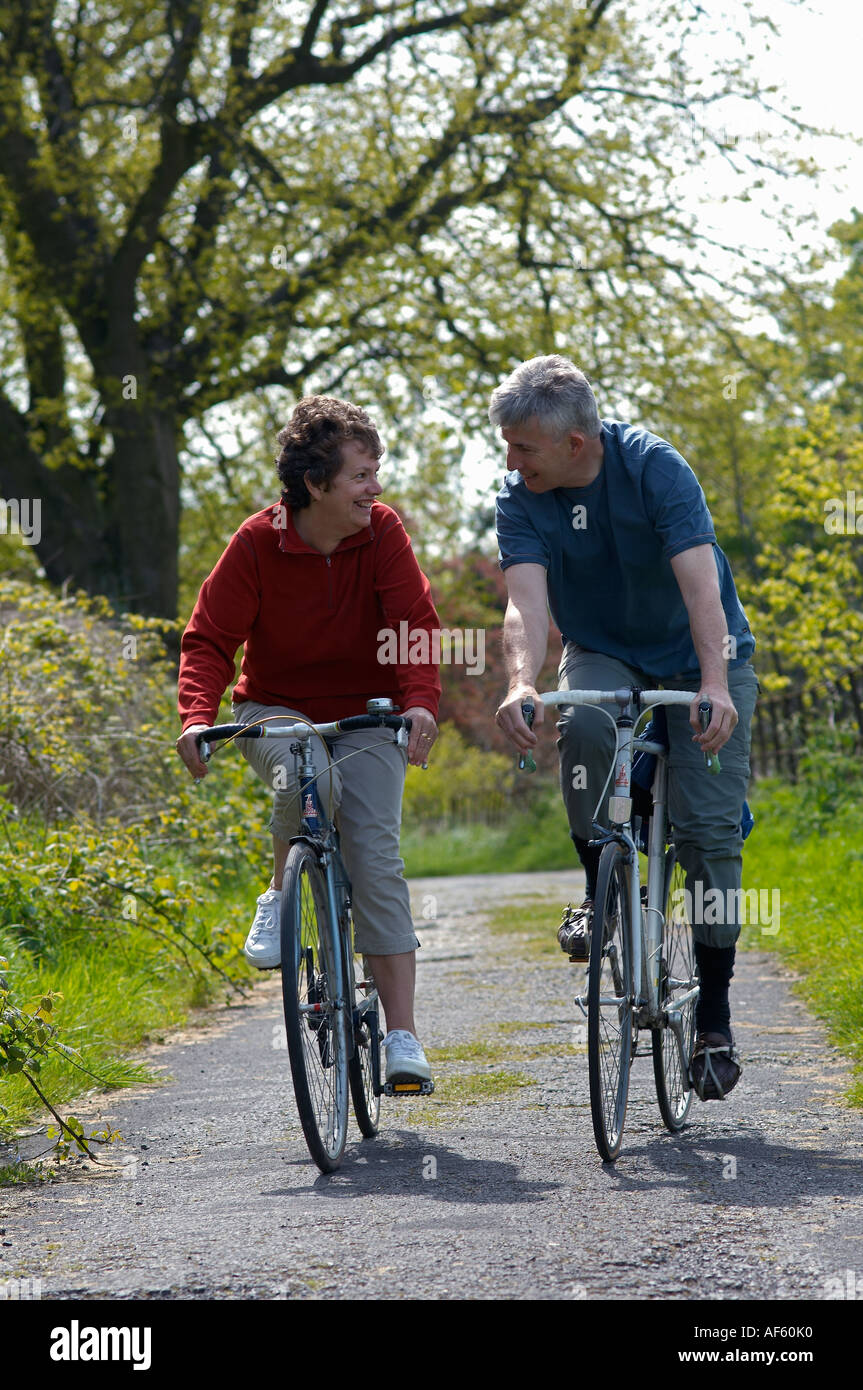 older ride their bicycles and enjoy the landscape with their bicycle in ...