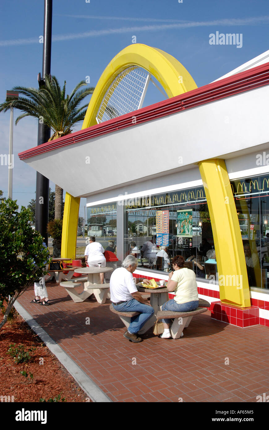 Adult couple eat outside outdoors at a fast food restaurant Stock Photo ...
