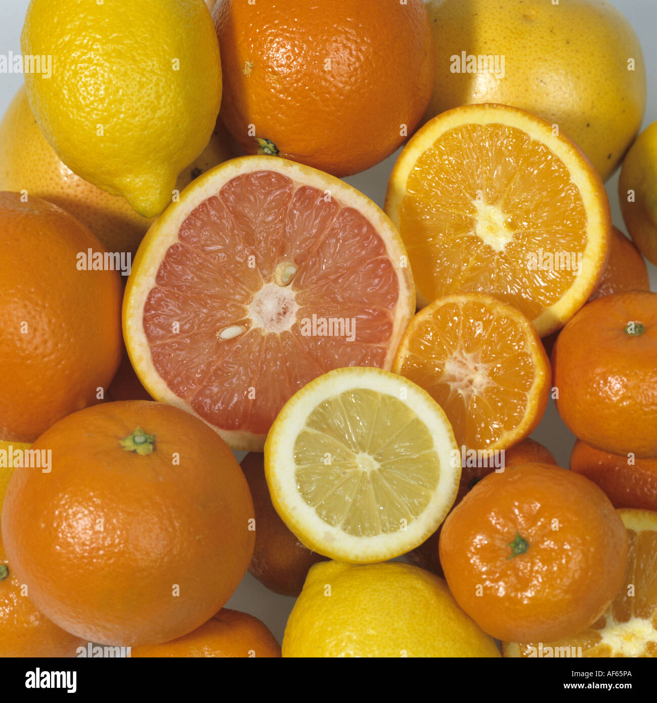Whole and sectioned lemons oranges grapefruit clementines in a group ...