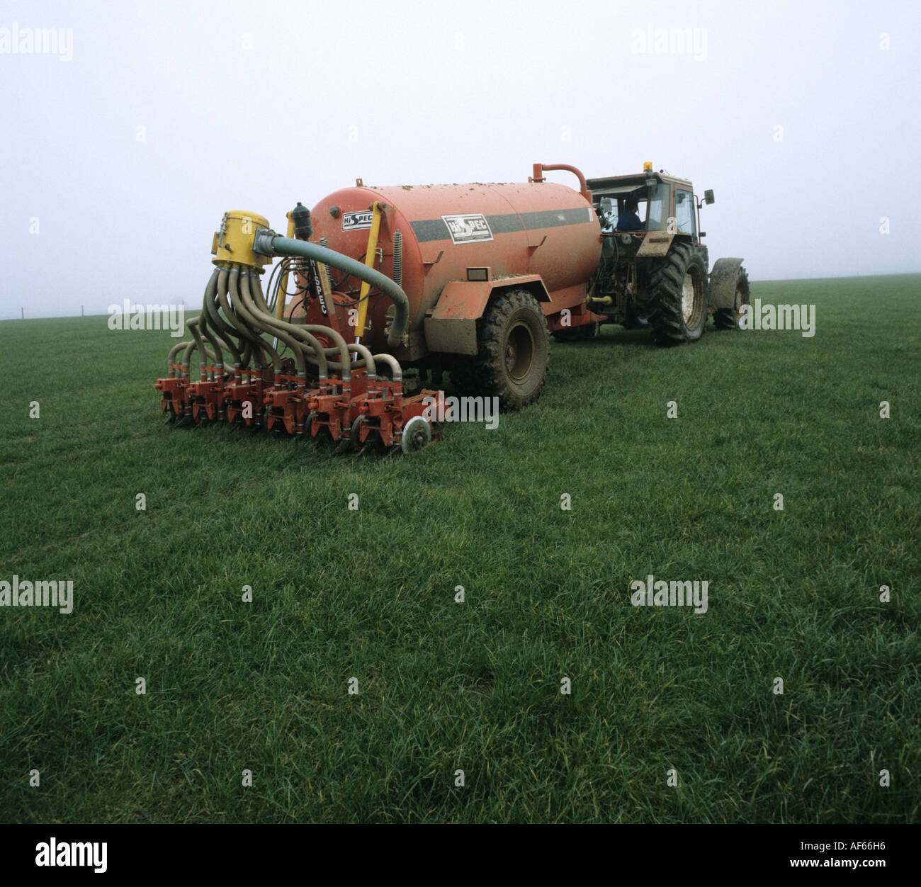 Hispec slurry injector injecting slurry into grassland Stock Photo - Alamy