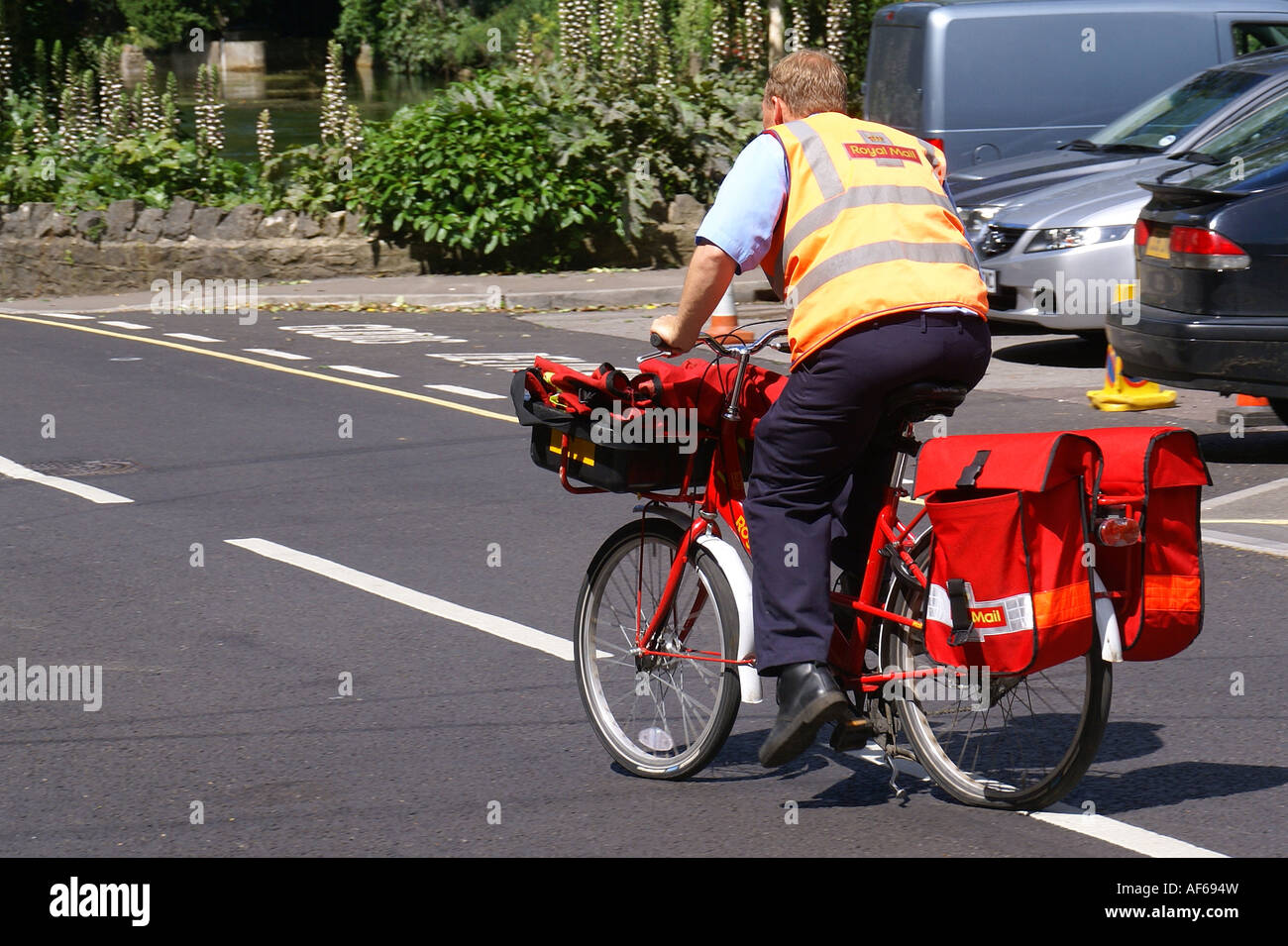 Postman on a bike Stock Photo - Alamy