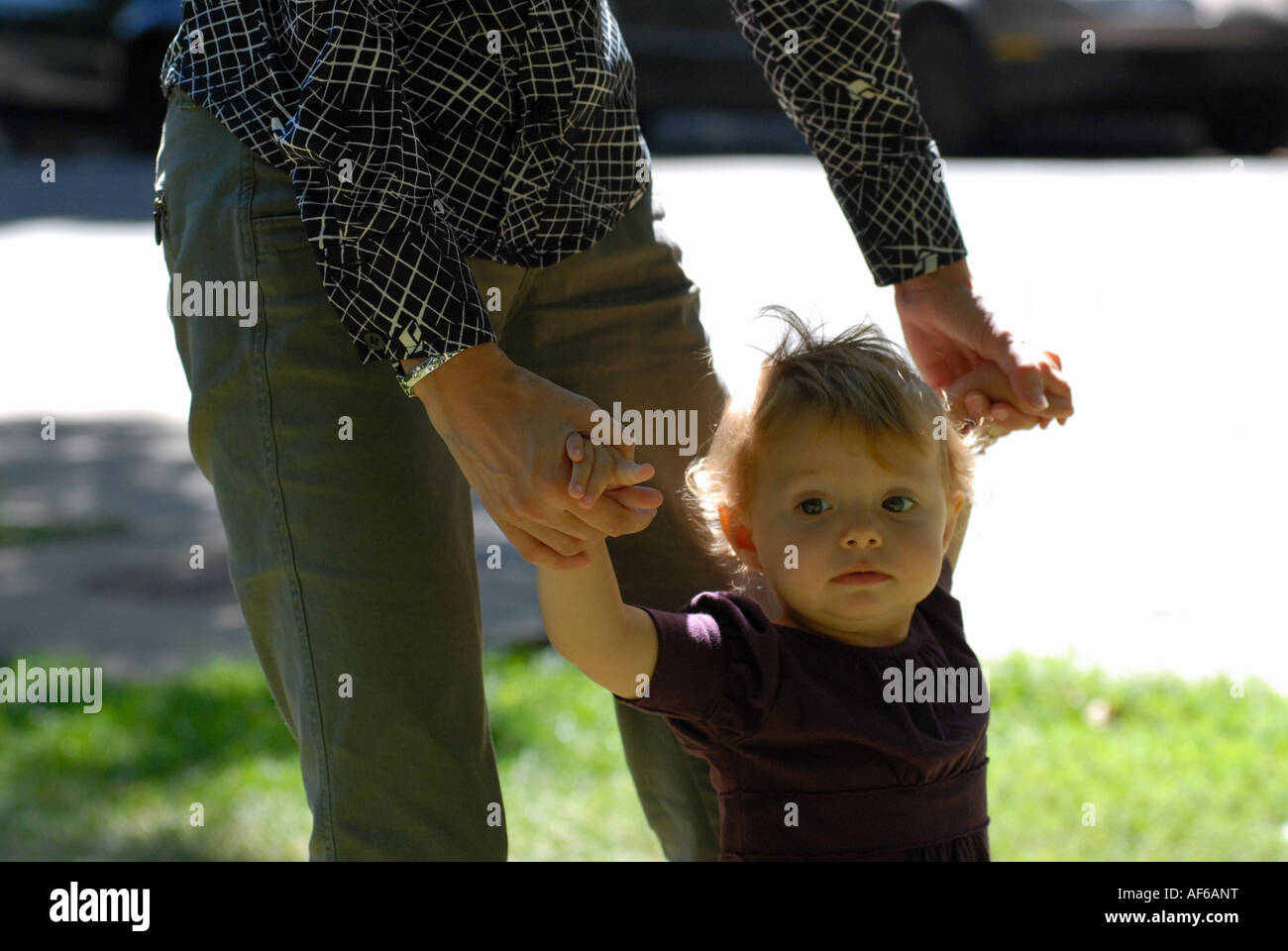 Child helping toddler walk hi-res stock photography and images - Alamy