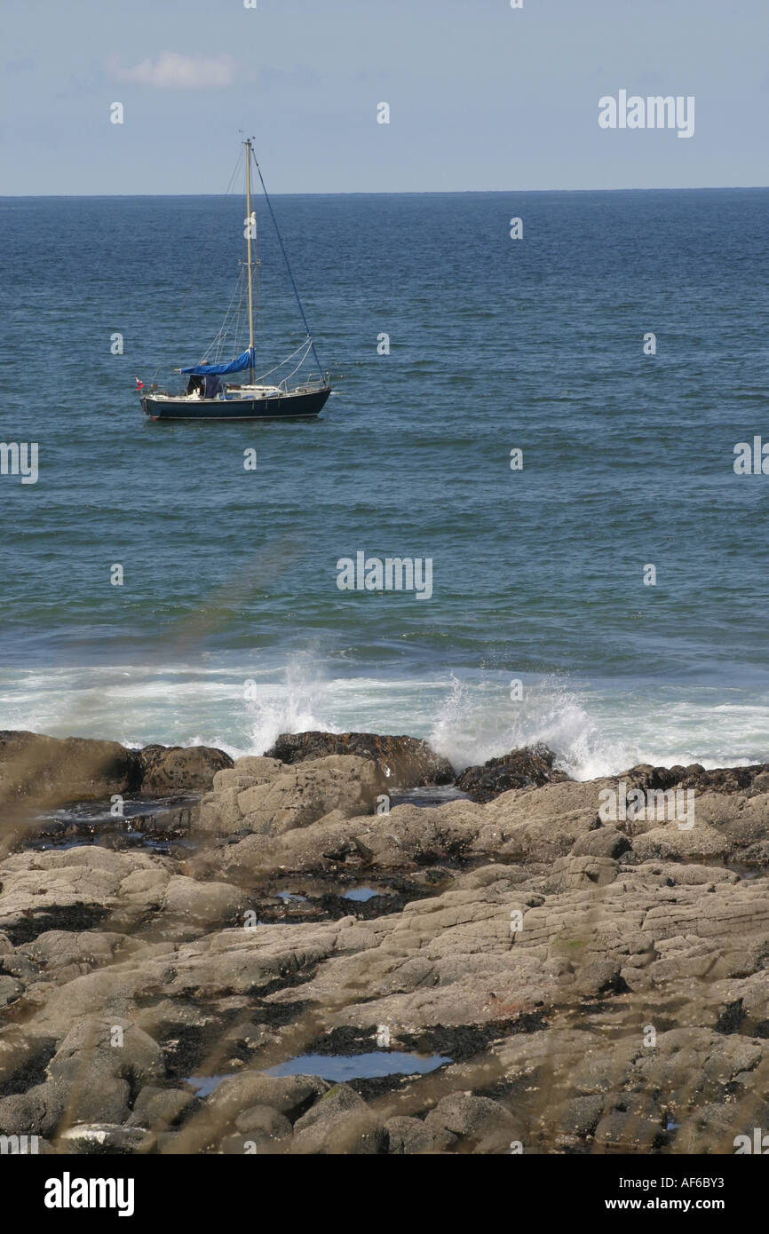 Small sailing boat off the Northern Ireland coast at Portstewart, County Londonderry, Northern ...
