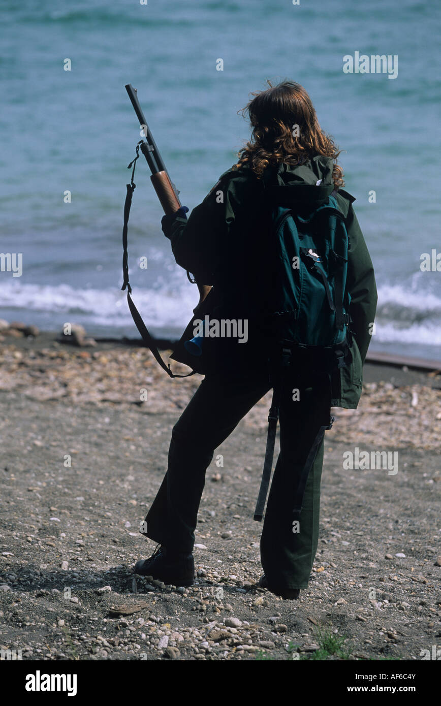 USA Alaska Katmai National Park Park Ranger with shotgun watches ...