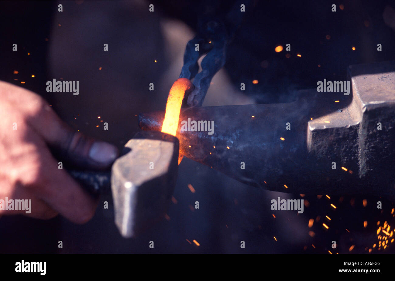 Blacksmith forging an iron ring on an anvil Stock Photo - Alamy