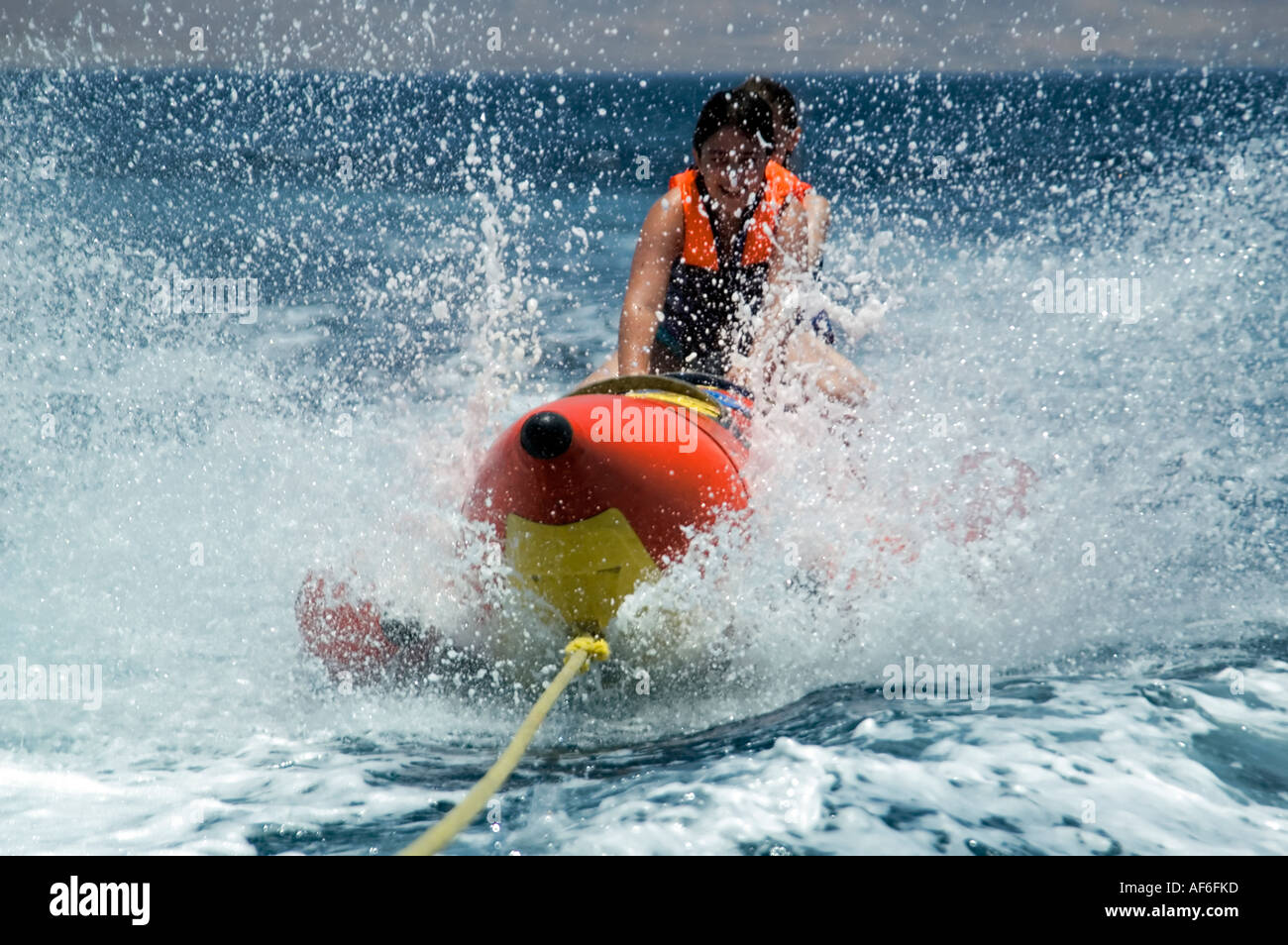 Horizontal close up of two young girls getting wet having fun on a ...