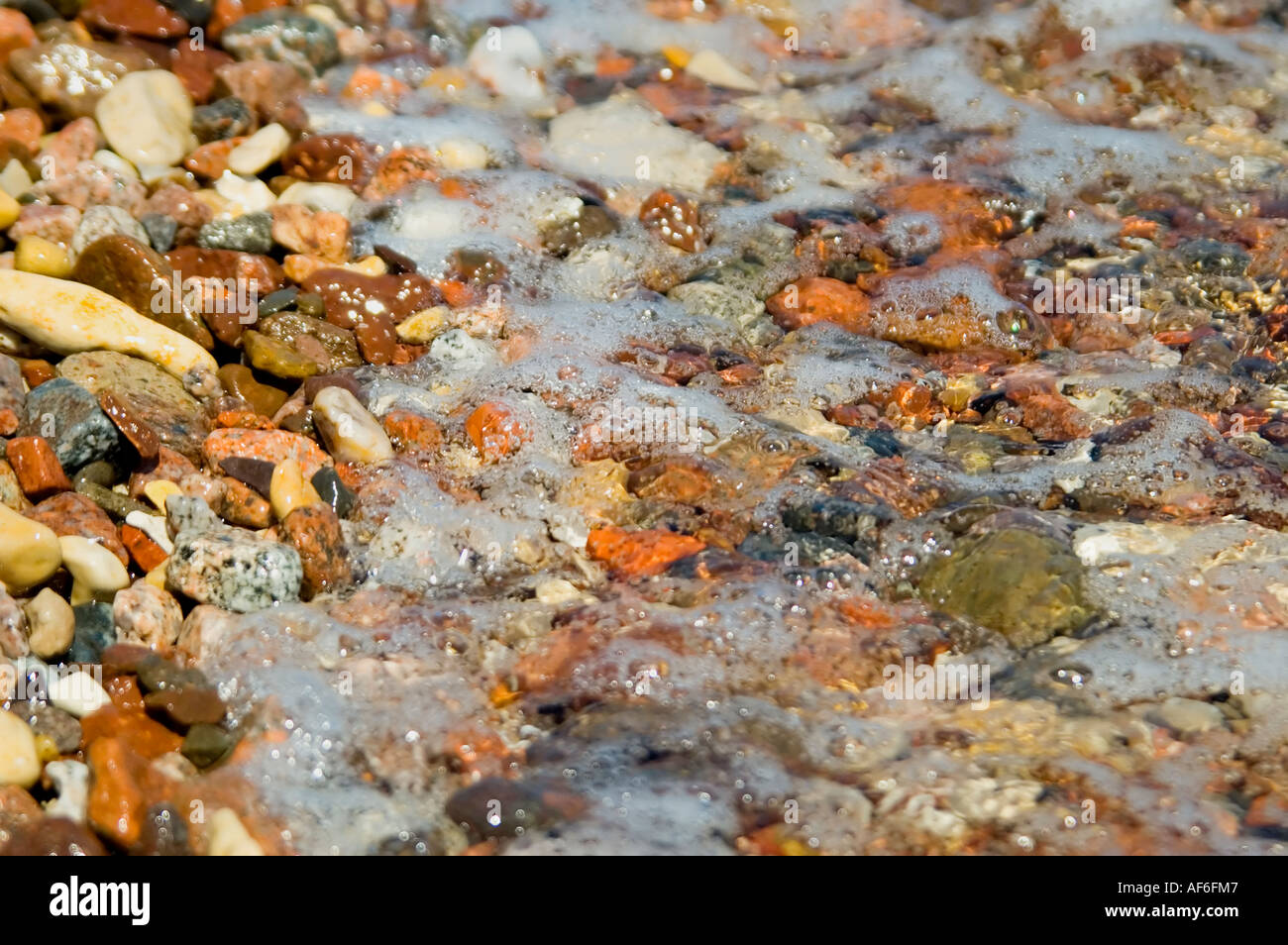 Lapping water over small pebbles hi-res stock photography and images ...