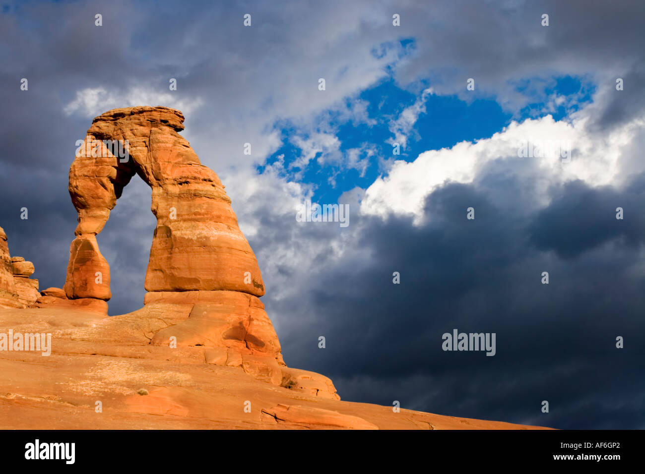 Delicate Arch Dark Cloud background Stock Photo - Alamy