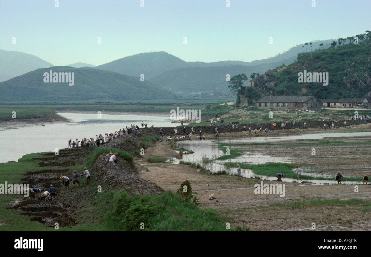 CHINA Zhejiang Flooding People rebuilding river defences after flood ...