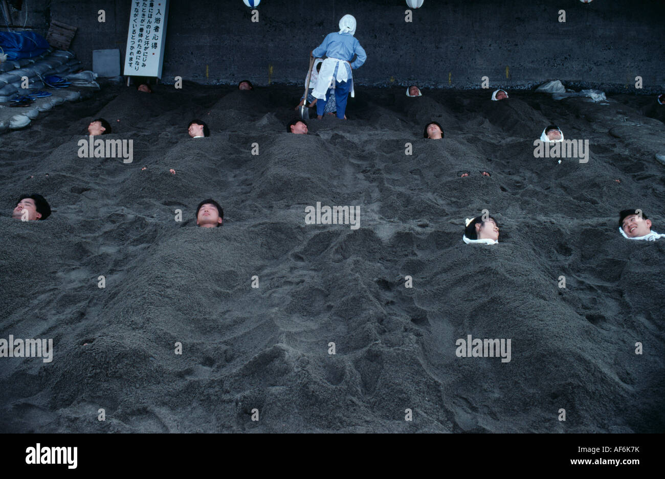 JAPAN Kyushu Ibusuki Volcanic Hot Sand Bath with people submerged in ...