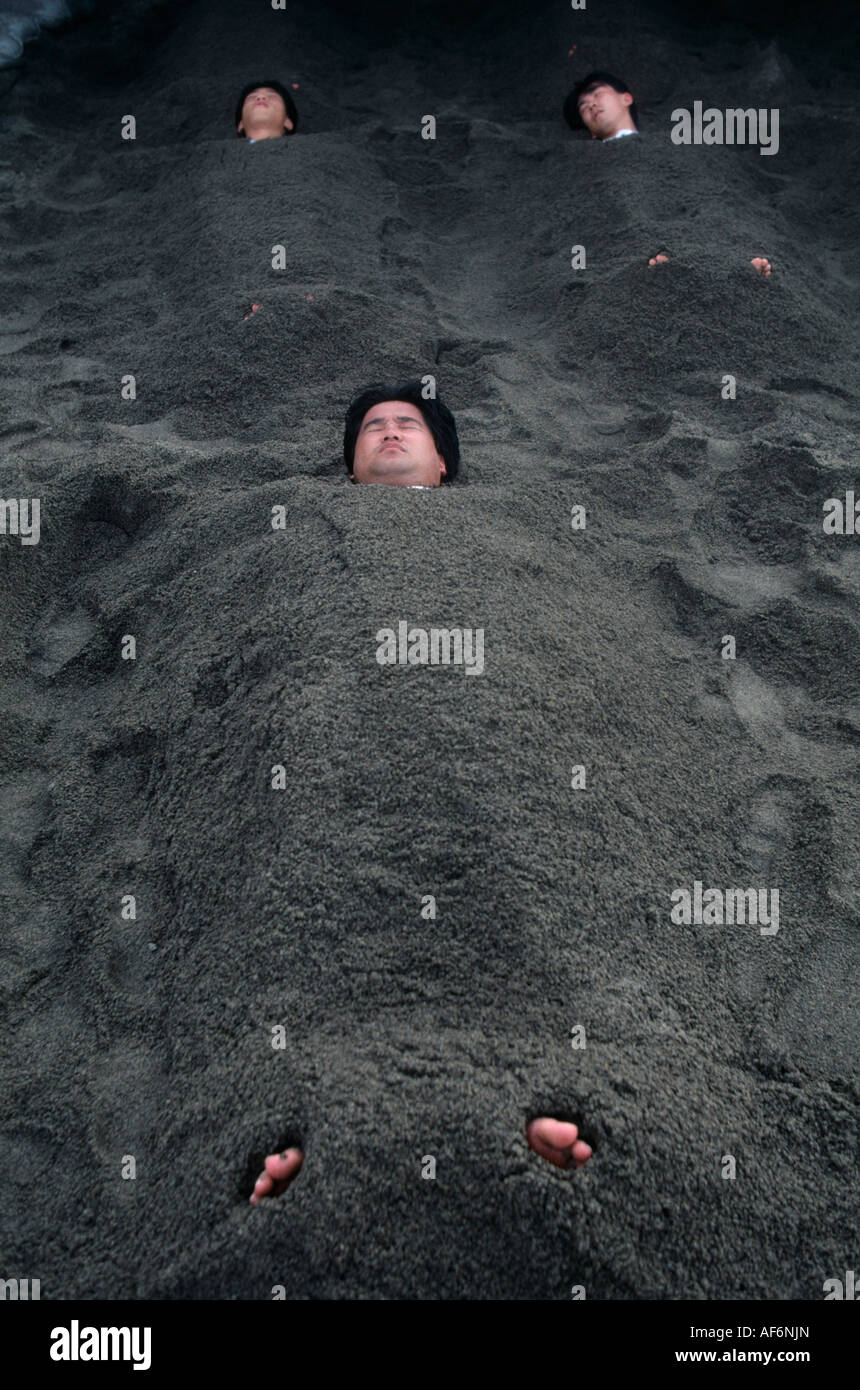 JAPAN Kyushu Ibusuki Sunabulo Volcanic Hot Sand Bath with men submerged ...